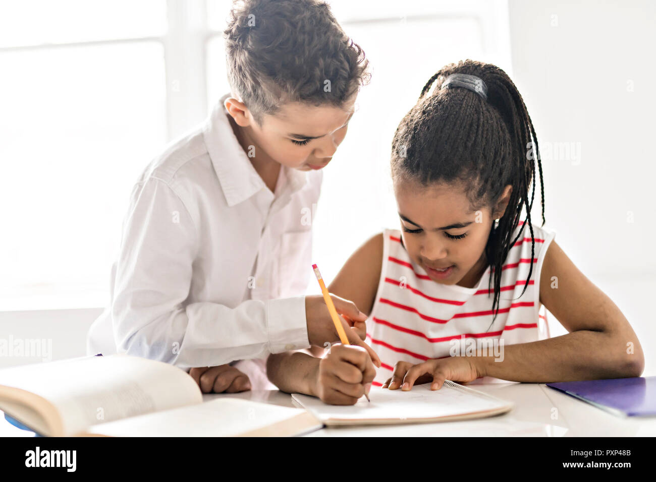 Two Black child doing homework at home Stock Photo - Alamy