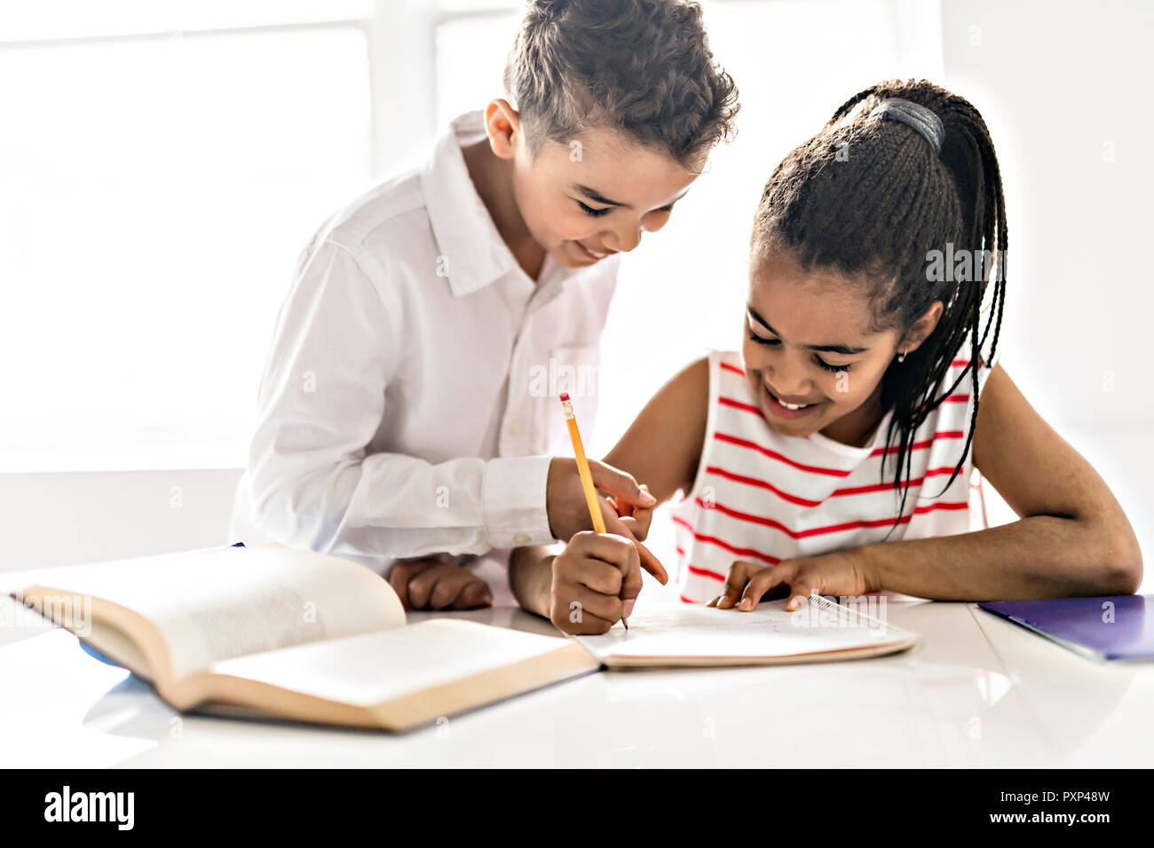Two Black child doing homework at home Stock Photo - Alamy
