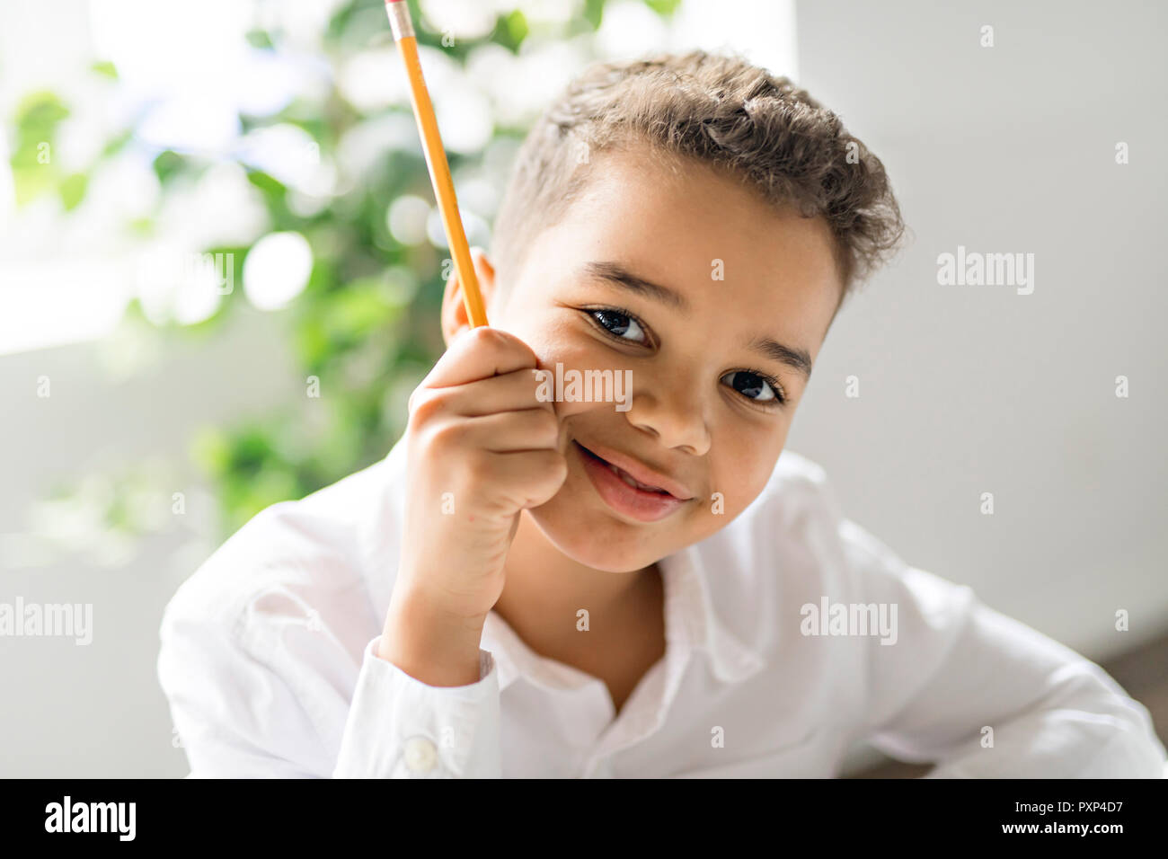A cute Black boy doing homework at home Stock Photo - Alamy