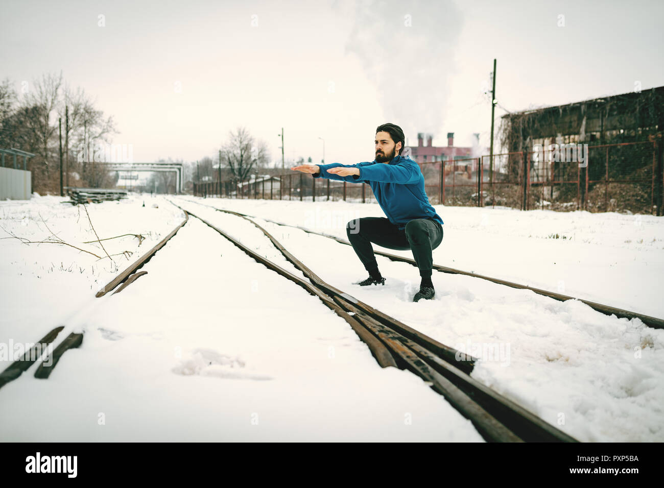 Young man crouching hi-res stock photography and images - Alamy