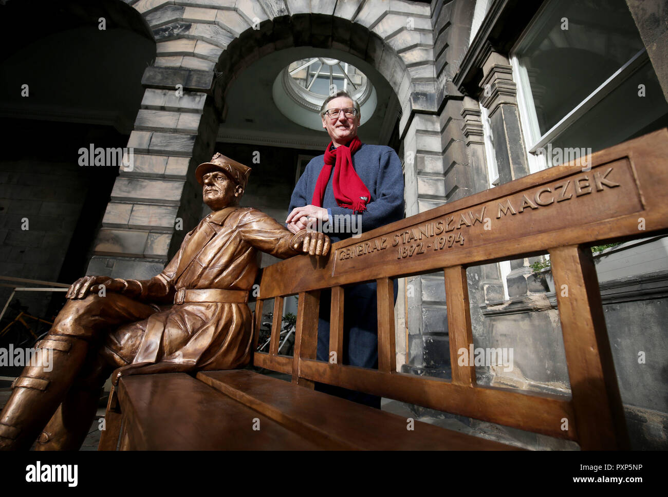 Artist and sculptor Bronislaw Krzysztof stands alongside the memorial ...