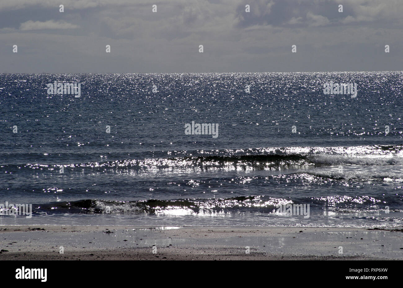 A dark, heavy, brooding, atmospheric and grey sky looks over a sun ...