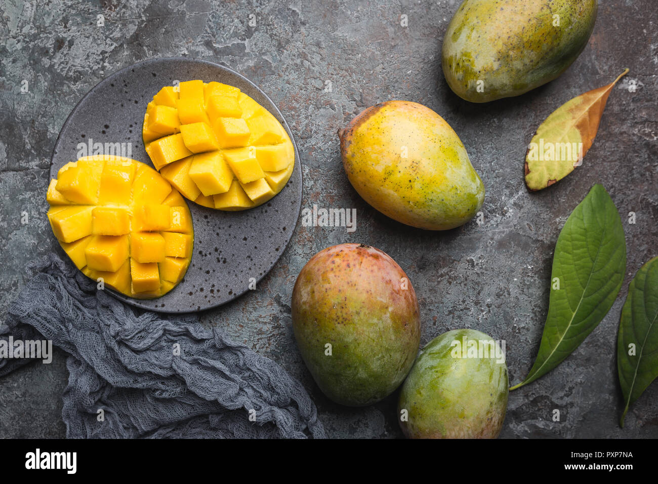 Fresh mango tropical fruits over gray background, top view with Copy ...