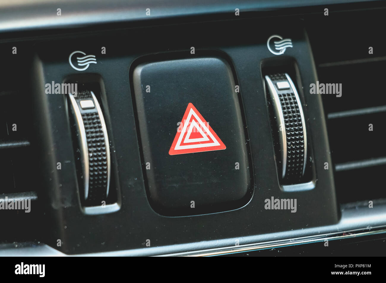 car emergency light button on a modern dashboard. Car interior details ...