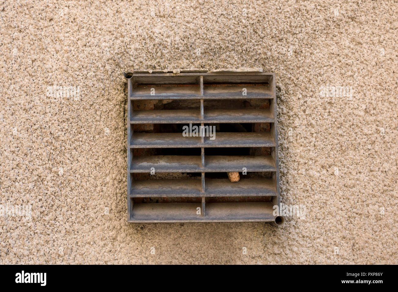 old metal ventilation grid on traditional british house wall outside ...