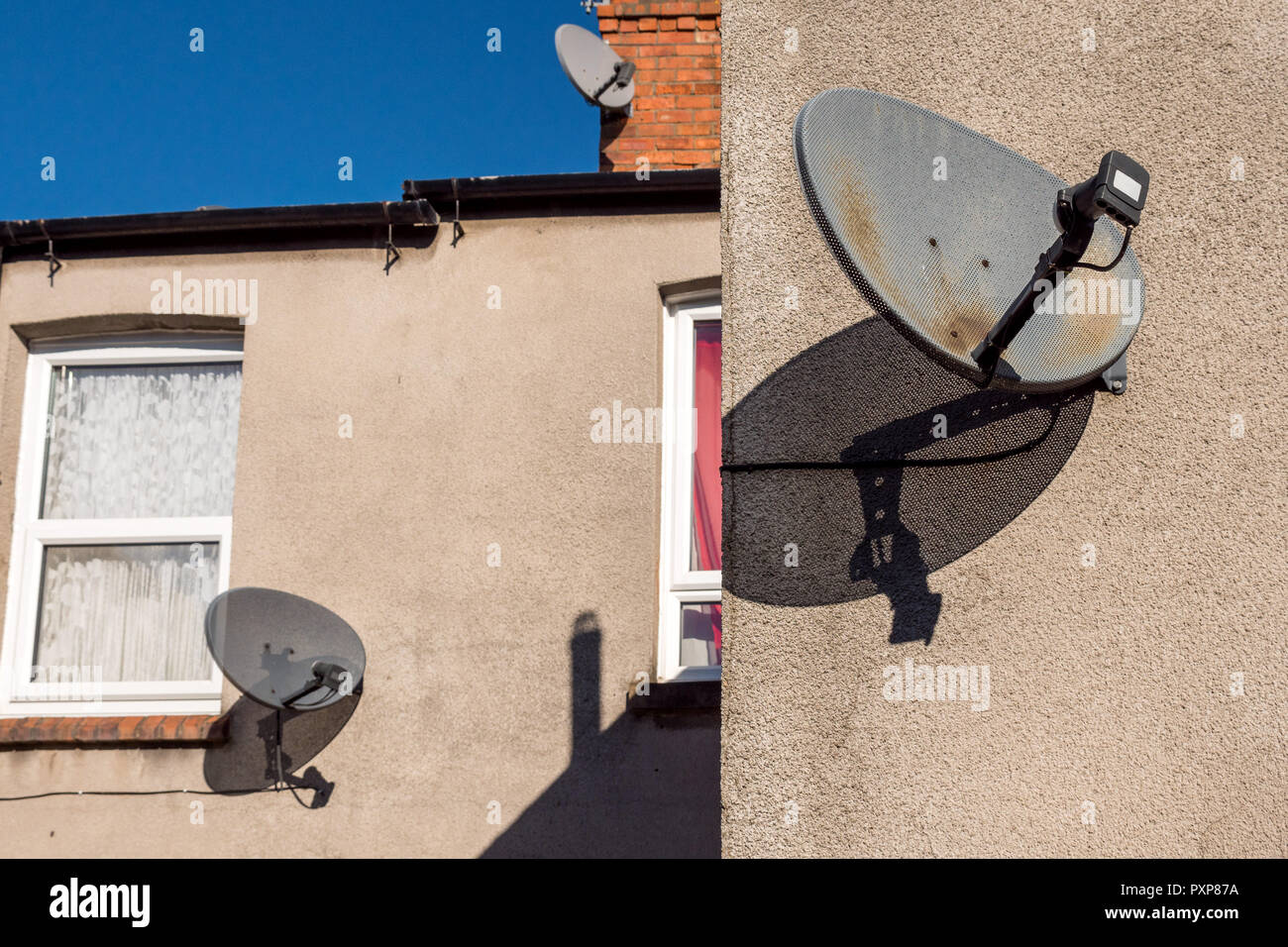 domestic satellite dish on traditional british house wall Stock Photo ...