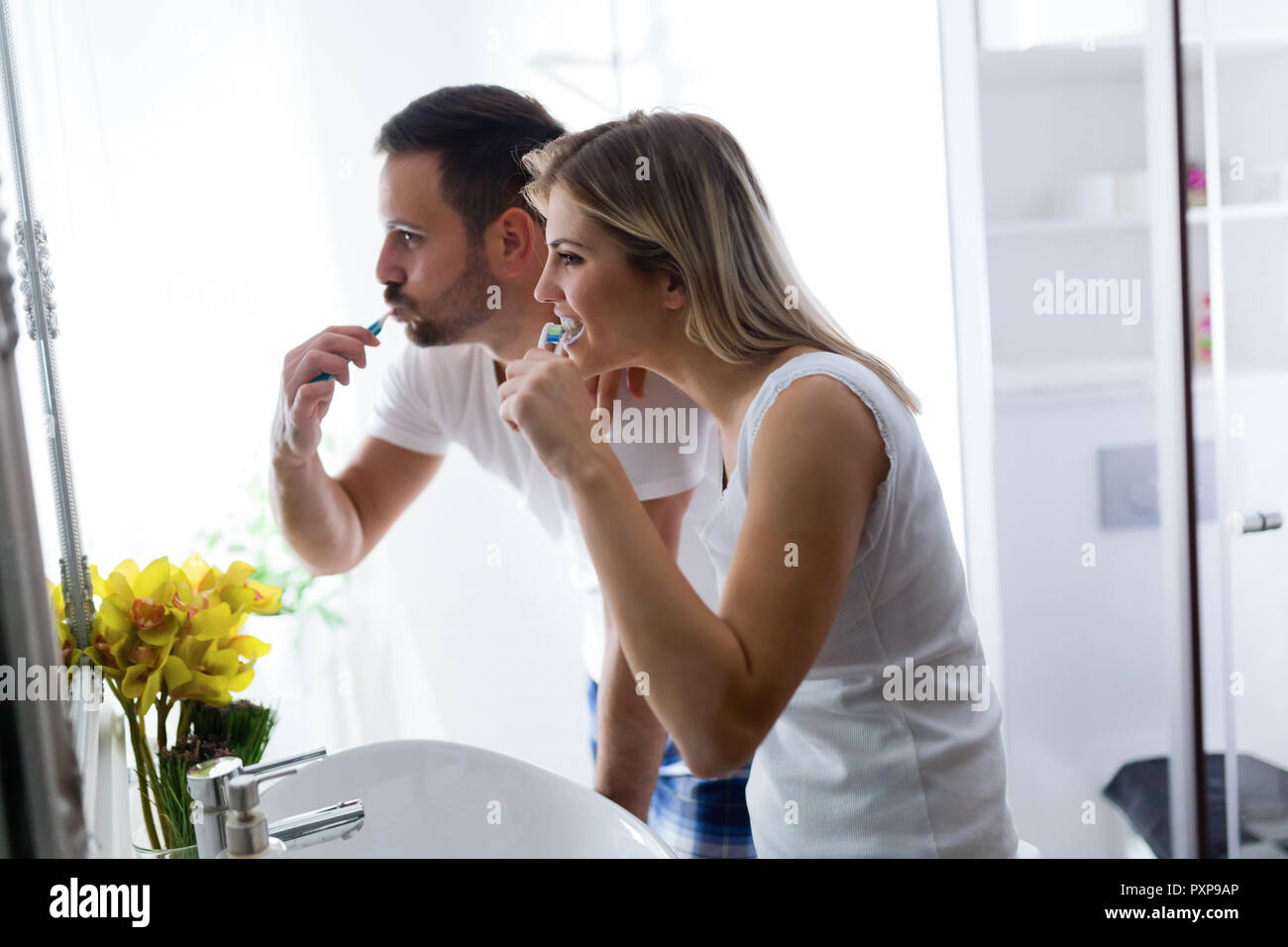 Attractive couple brushing teeth in morning together Stock Photo - Alamy