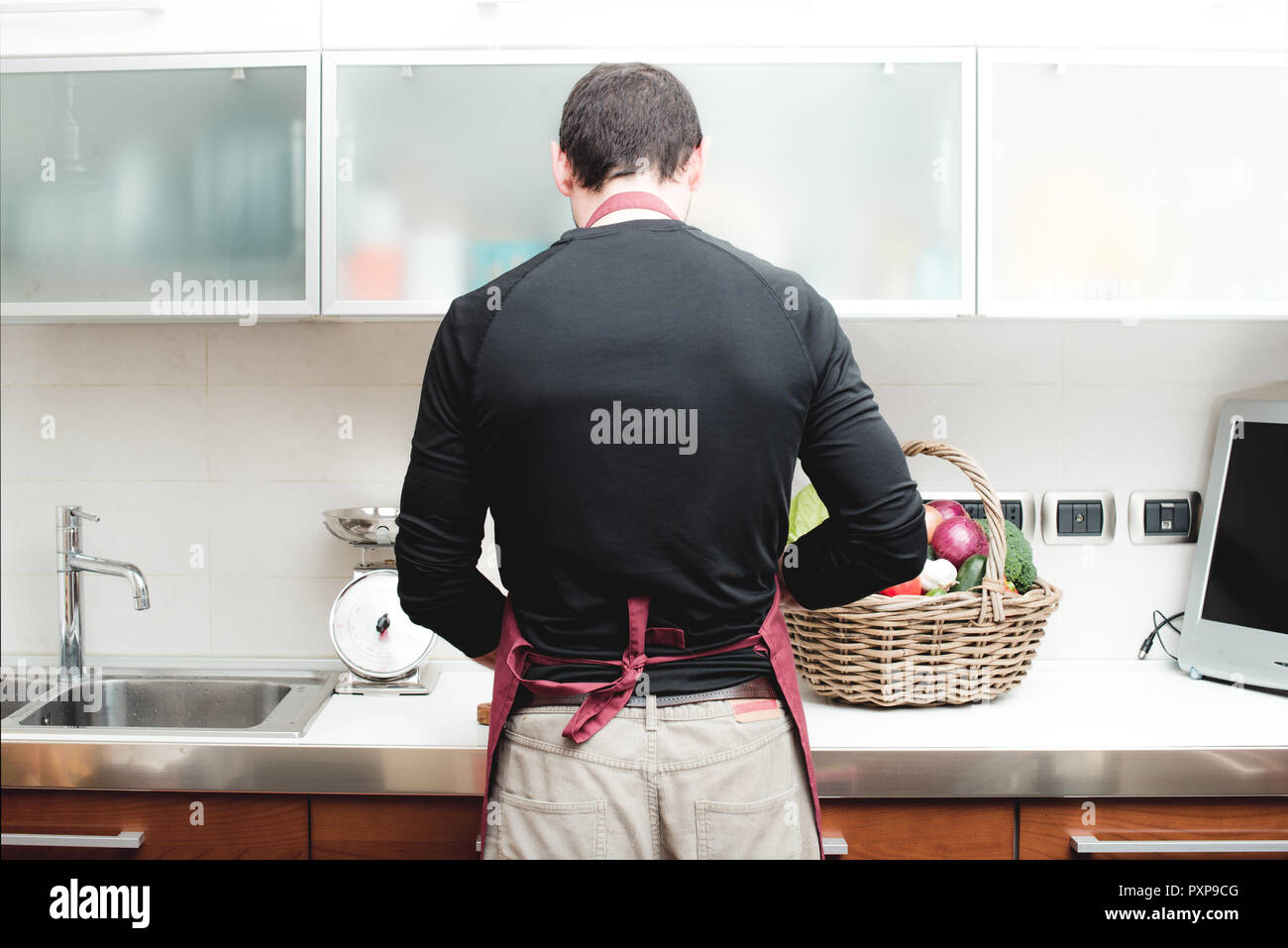 man prepare vegetables over the bench in the kitchen Stock Photo - Alamy