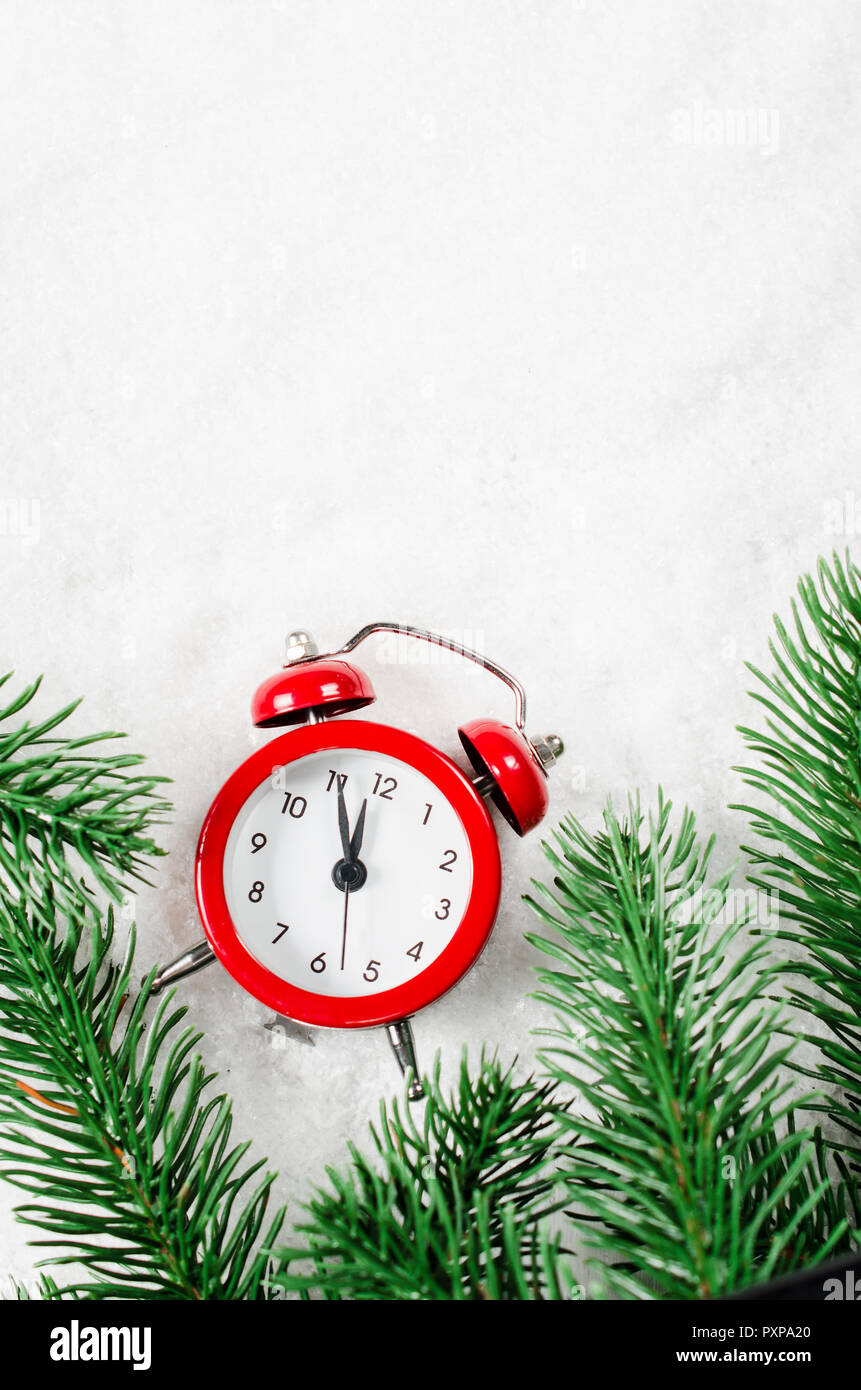Christmas Eve and New Years clock at midnight with fir tree branches on ...