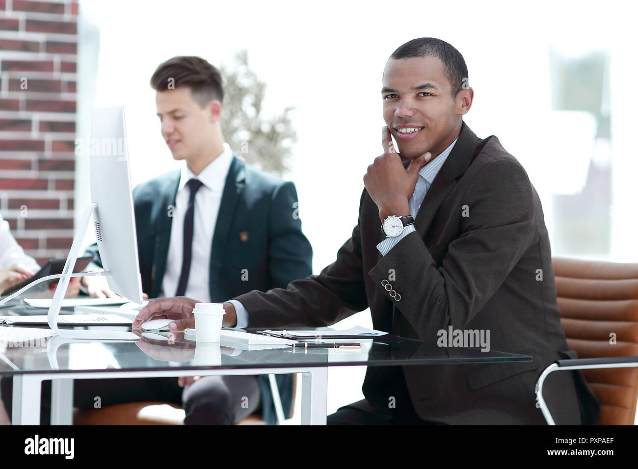 Boss sitting behind desk hi-res stock photography and images - Alamy