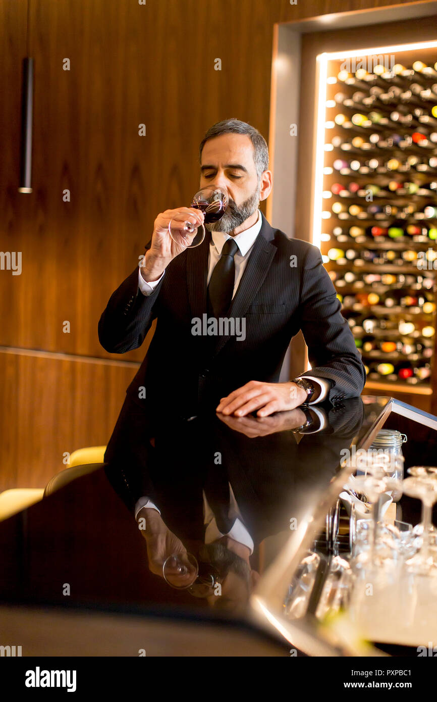 Portrait of senior handsome man drinking red wine Stock Photo - Alamy