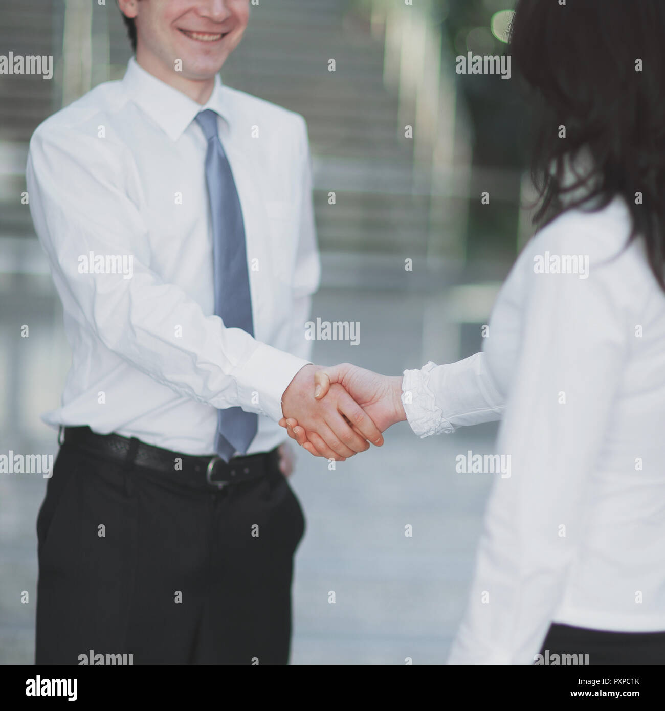 welcoming handshake of a Manager and the customer in the office Stock ...