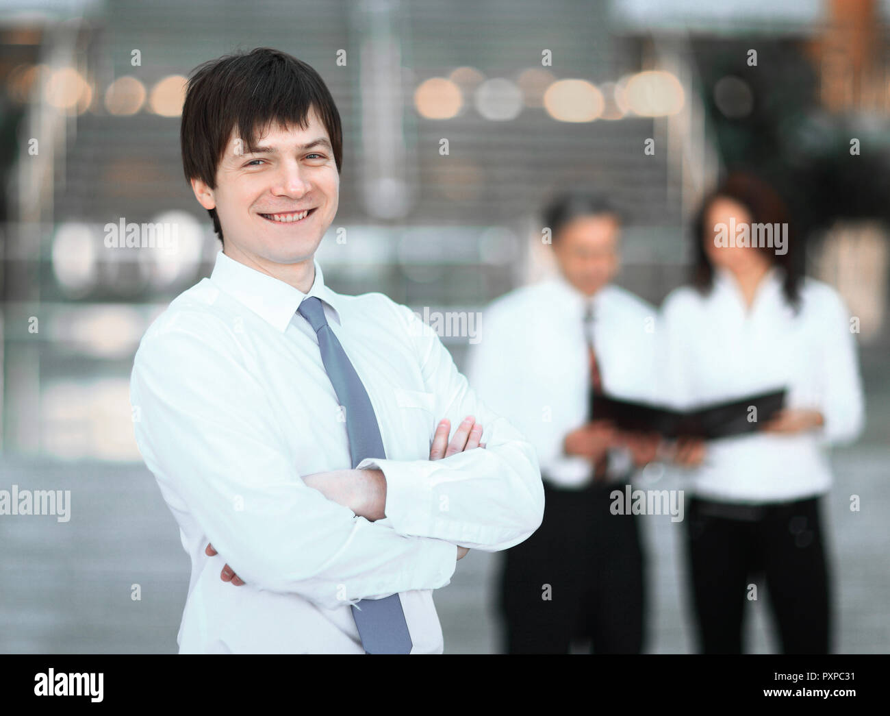 successful employee in the background of the office Stock Photo - Alamy