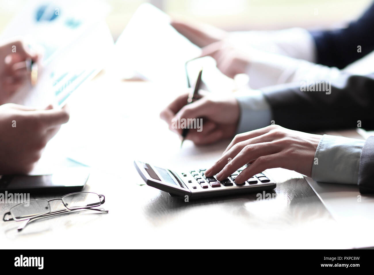 close up. business team makes calculations using a calculator Stock ...