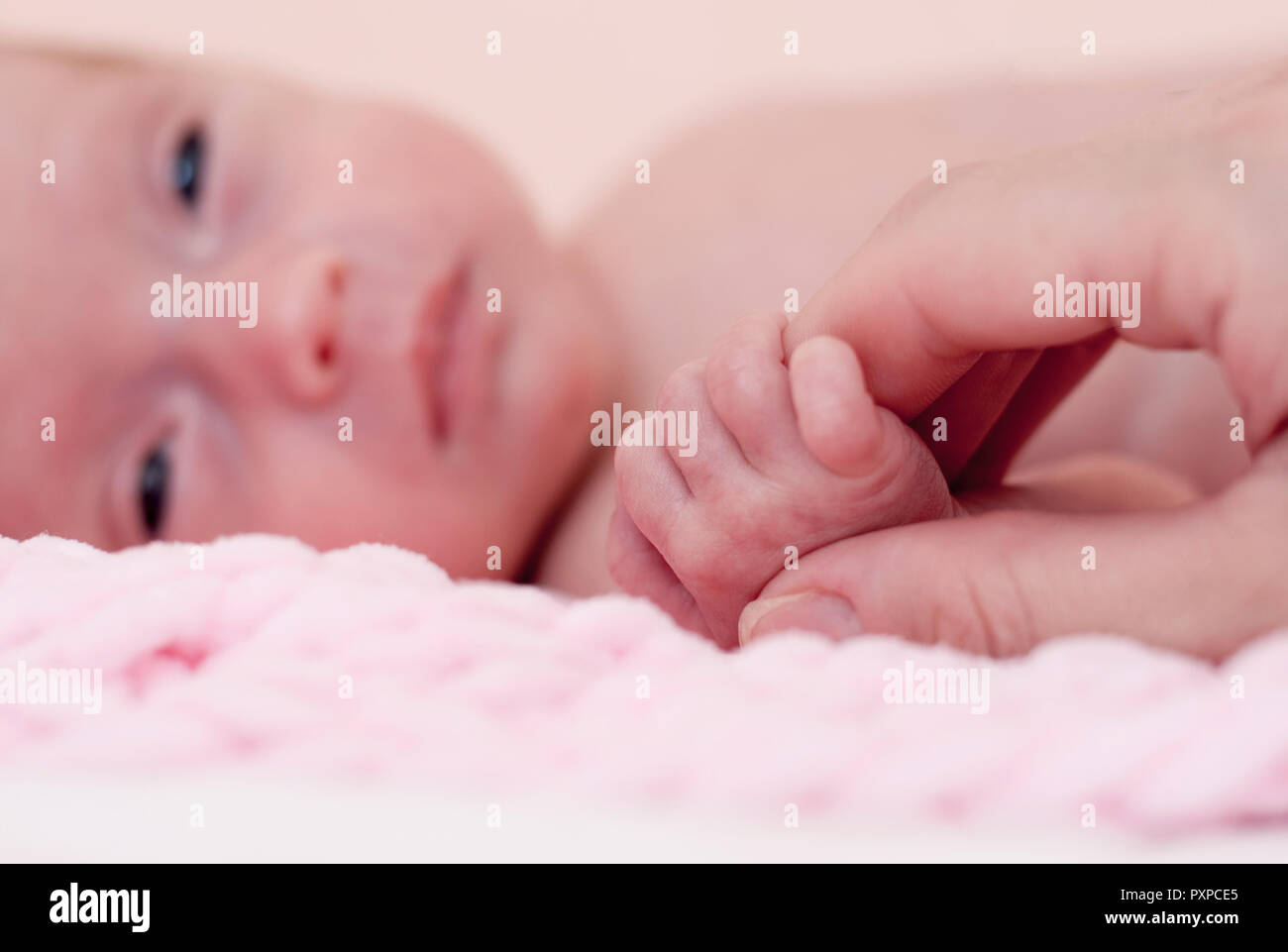 Premature baby holding his mother's hand Stock Photo - Alamy