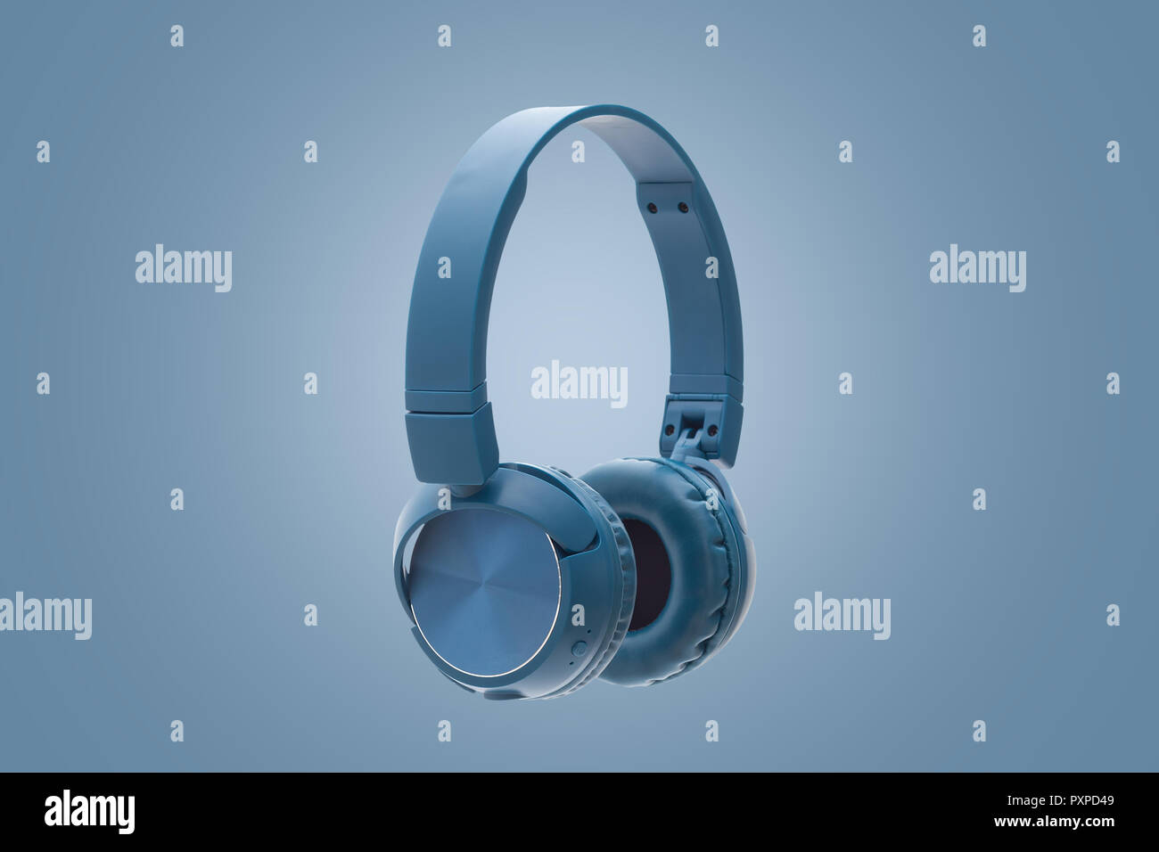 bluetooth blue headphone on blue background studio pack shot equipment ...