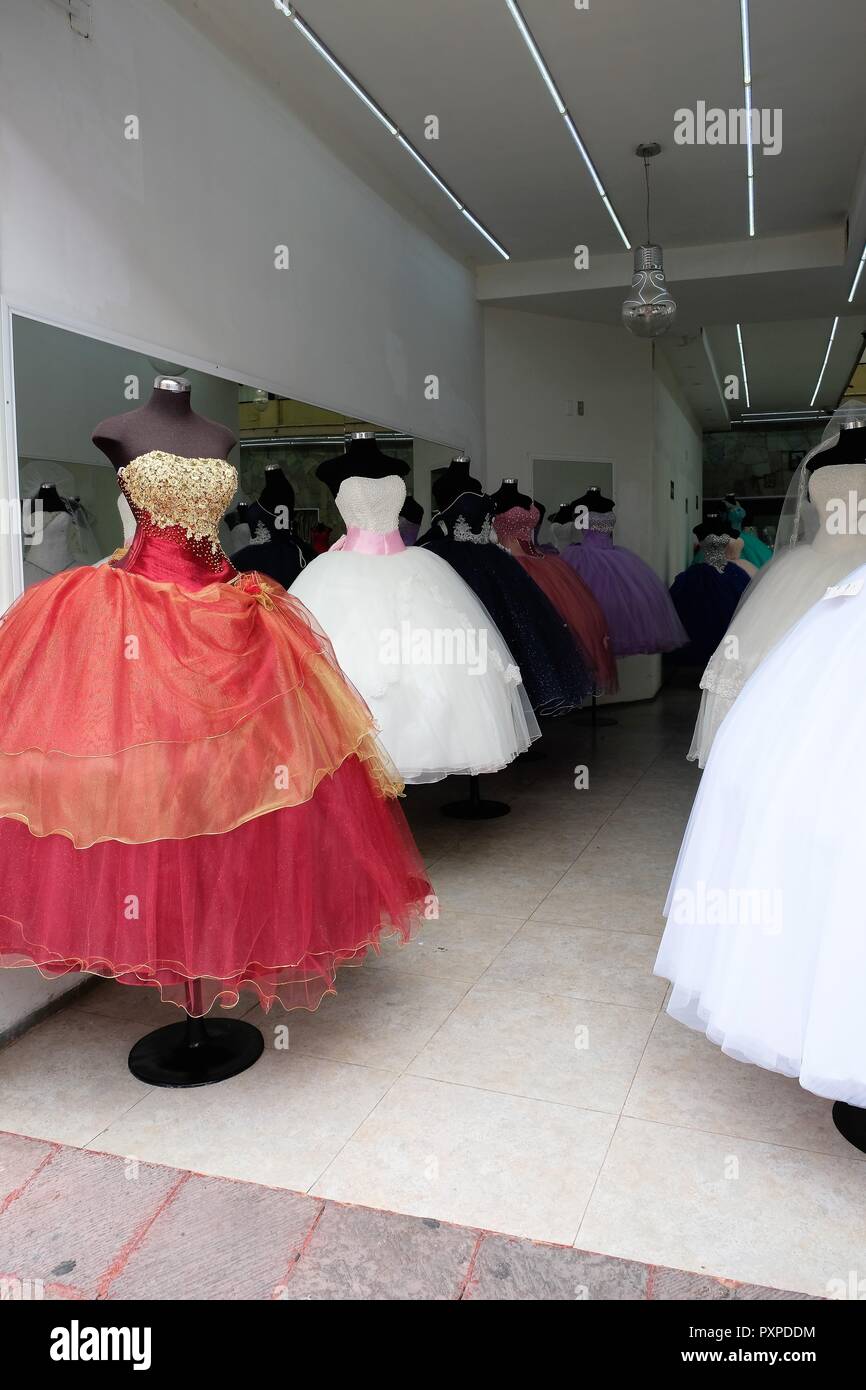 Mexican wedding and quinceañera dresses on display at a store in ...