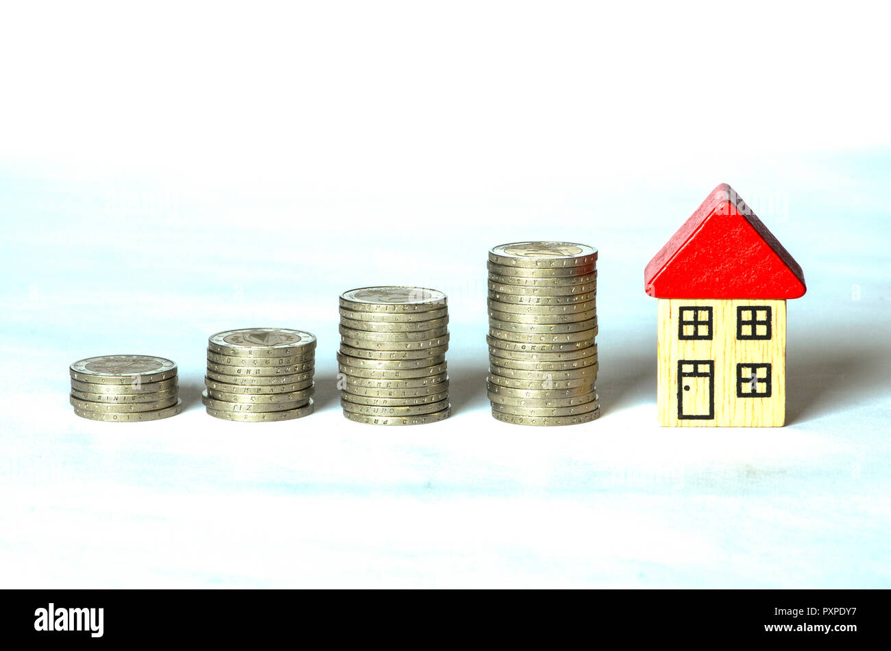 several piles of money on white background Stock Photo - Alamy