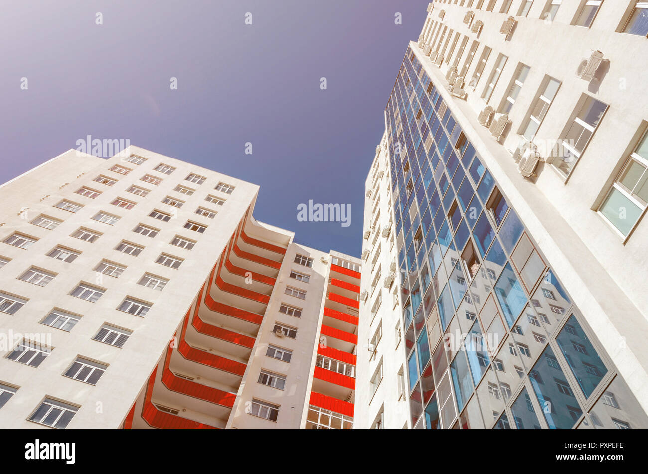 View of a residential building from the bottom up. White house with red ...