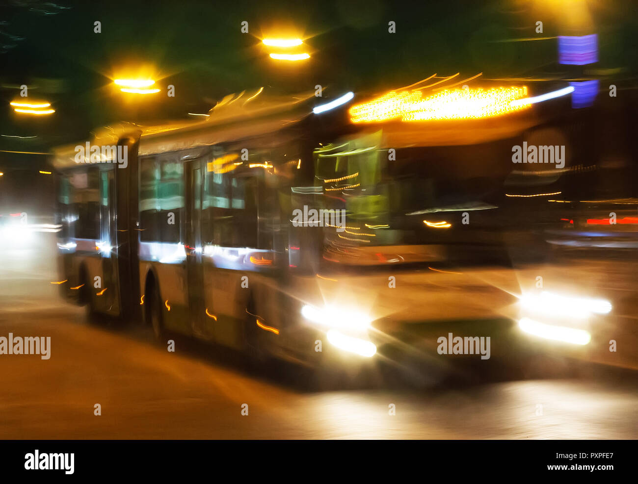 public bus is moving around the night city Stock Photo - Alamy