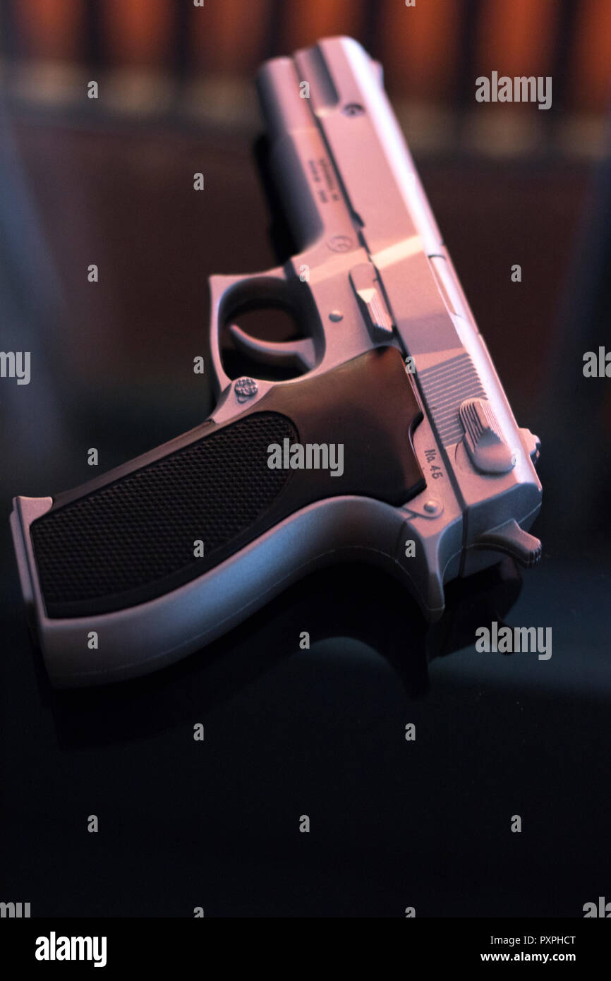 Pistol automatic handgun weapon on table in hotel bedroom in ...