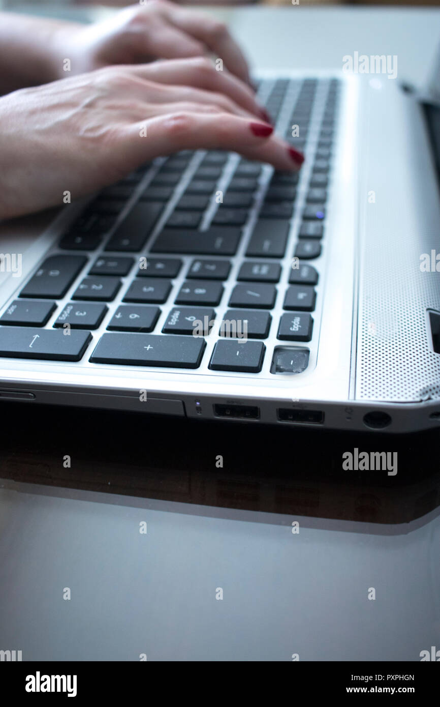 Secretary typist typing on laptop pc computer keyboard keys with hands ...