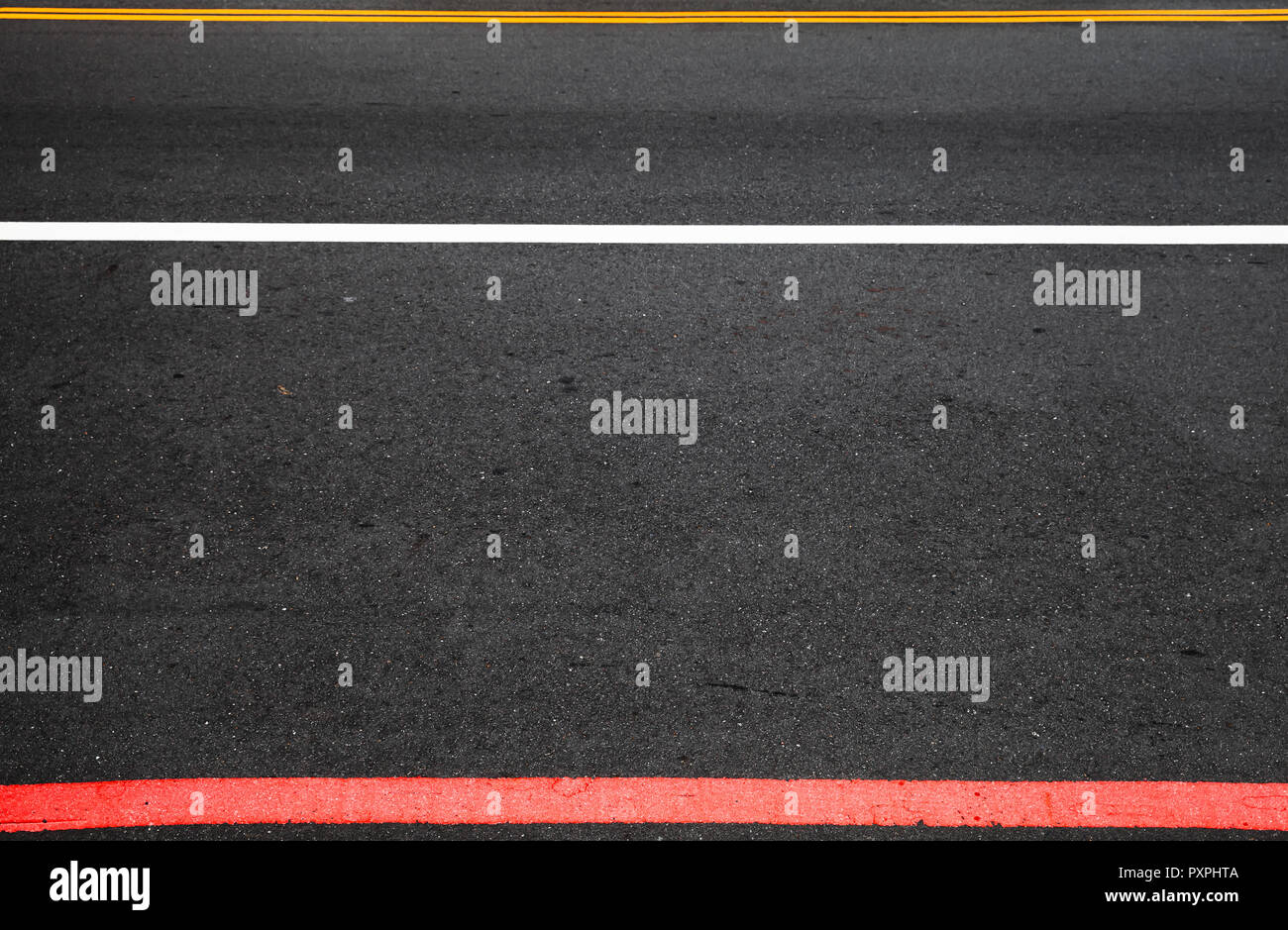 Highway road marking. Yellow, white and red lines over dark asphalt ...