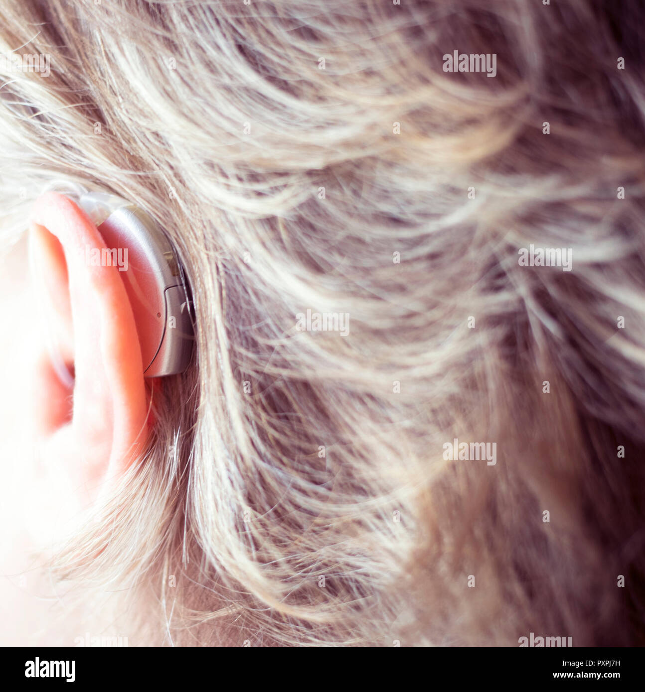 Deaf lady with modern technology digital hearing aid in her ear Stock ...