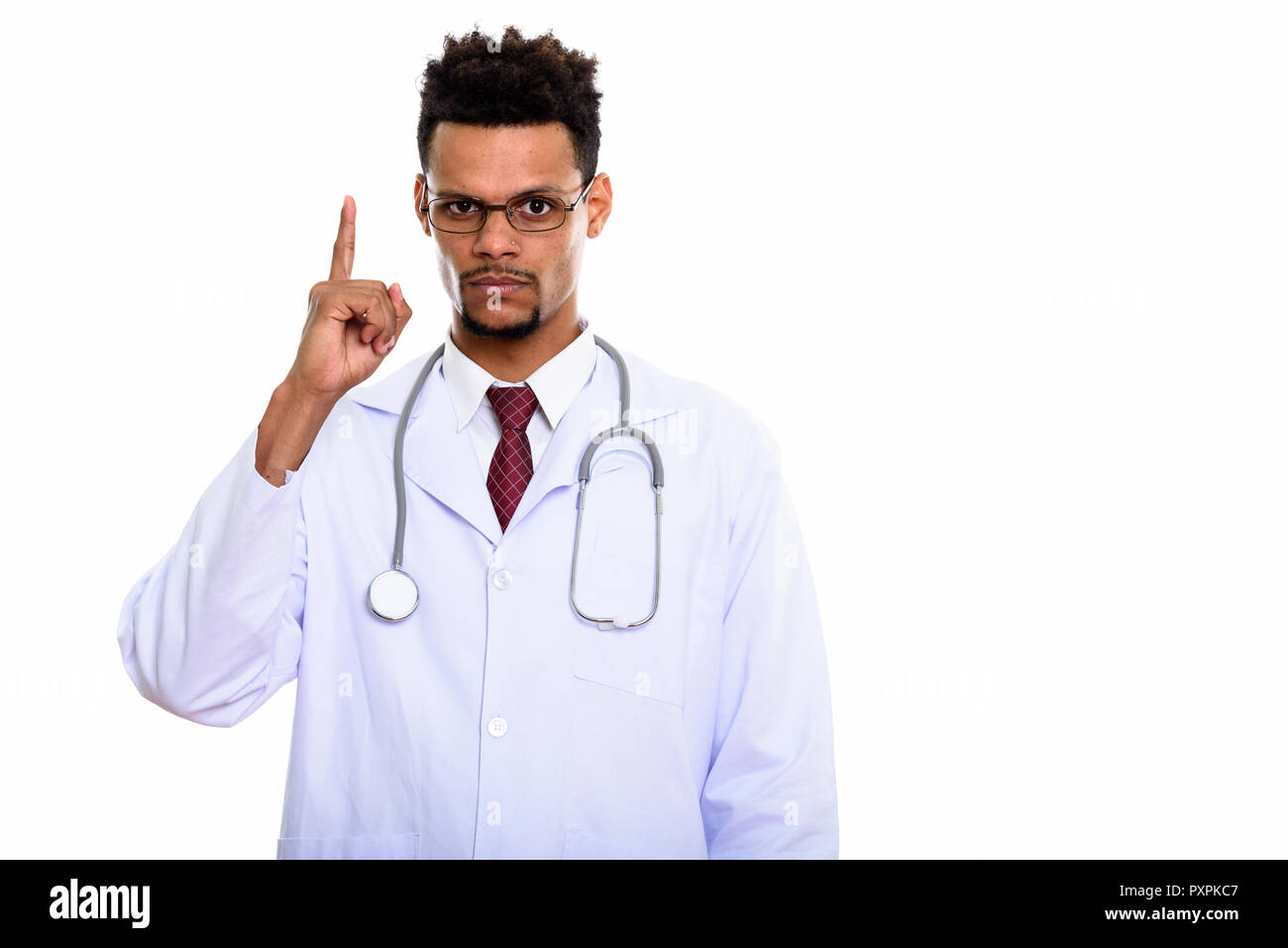 Studio shot of young African man doctor pointing finger up Stock Photo ...