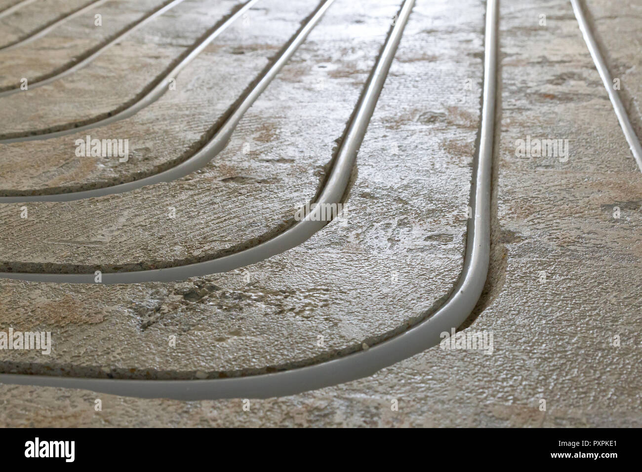 Water underfloor heating pipes in a concrete floor Stock Photo - Alamy