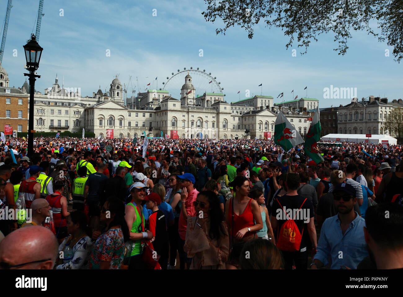 Family and friends waiting at the finish line, runners recovering after ...
