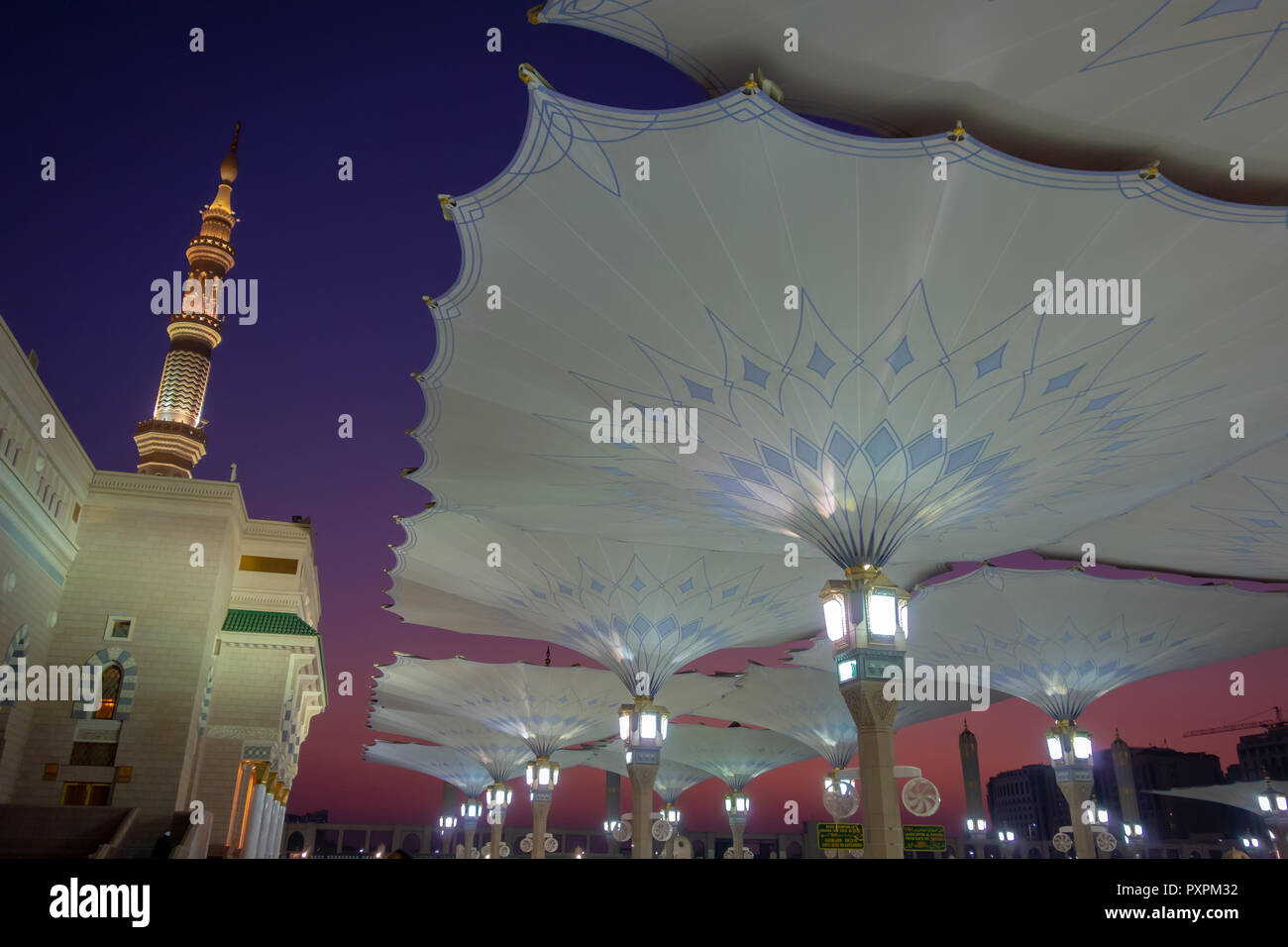 Giant canopies at Nabawi mosque in Medina, Saudi Arabia.during sunrise ...