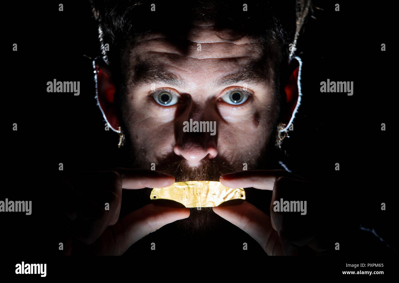 Yorkshire Museum's Assistant Curator of Archaeology Adam Parker holds a ...