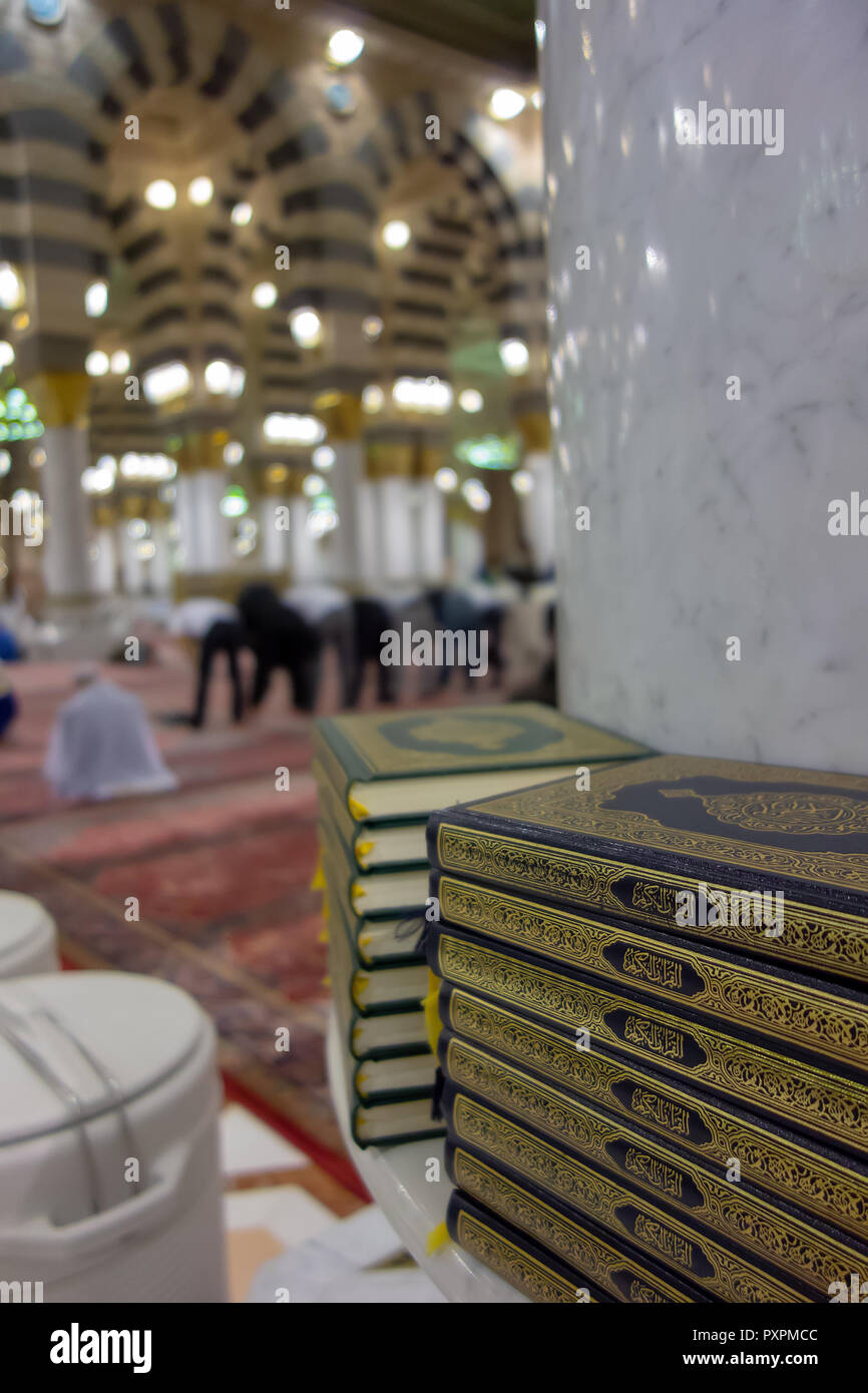 Stack of Quran (Koran) inside a mosque in Medina, Saudi Arabia in toned ...