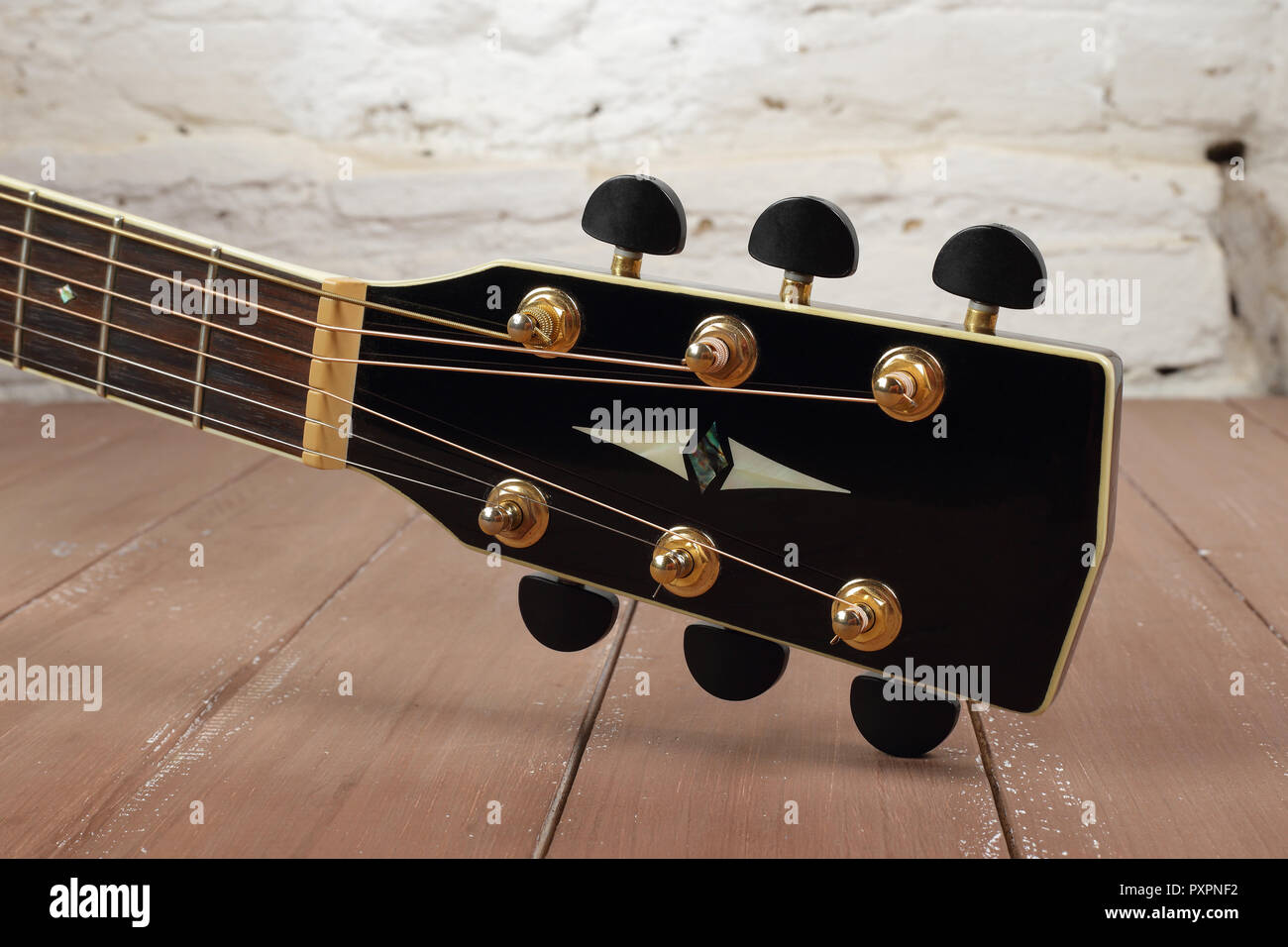 Musical instrument - Neck acoustic guitar on a wood and white brick ...