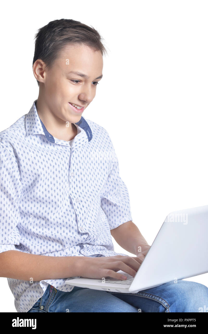Portrait of teenage boy using laptop isolated on white background Stock ...