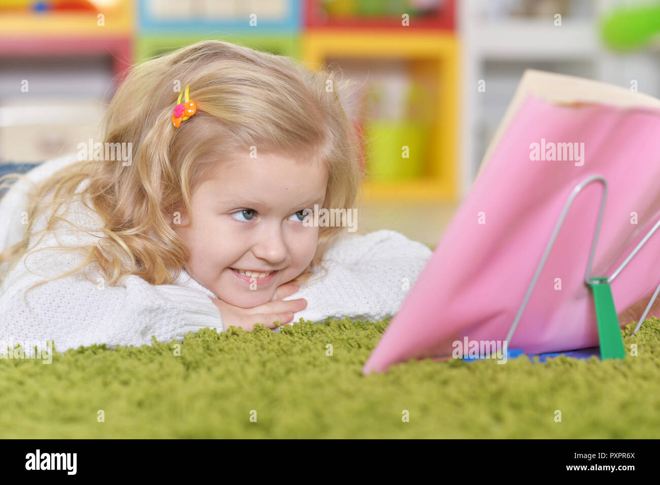 Cute happy girl studying at home lying on the floor Stock Photo - Alamy
