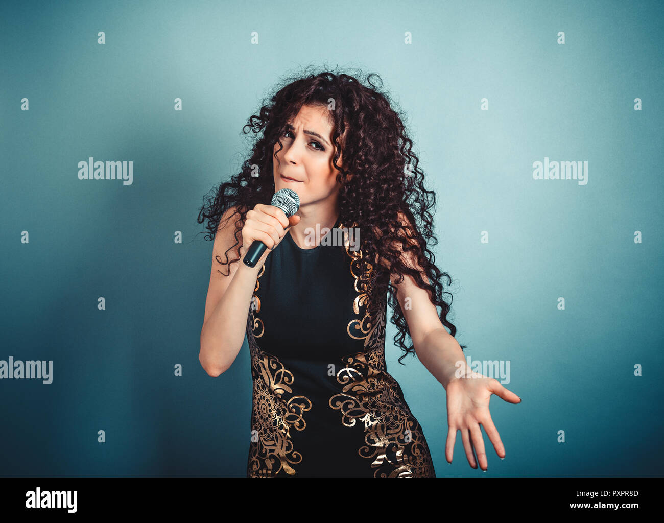 Expressive woman lady girl singing looking at you with microphone in ...