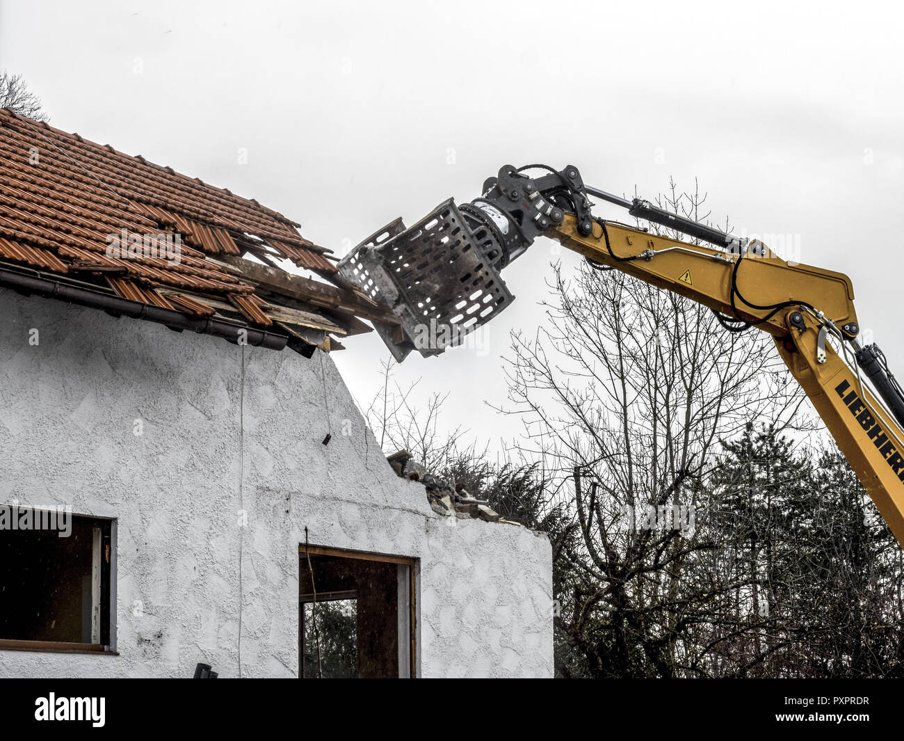 Excavator demolishing a house Stock Photo - Alamy