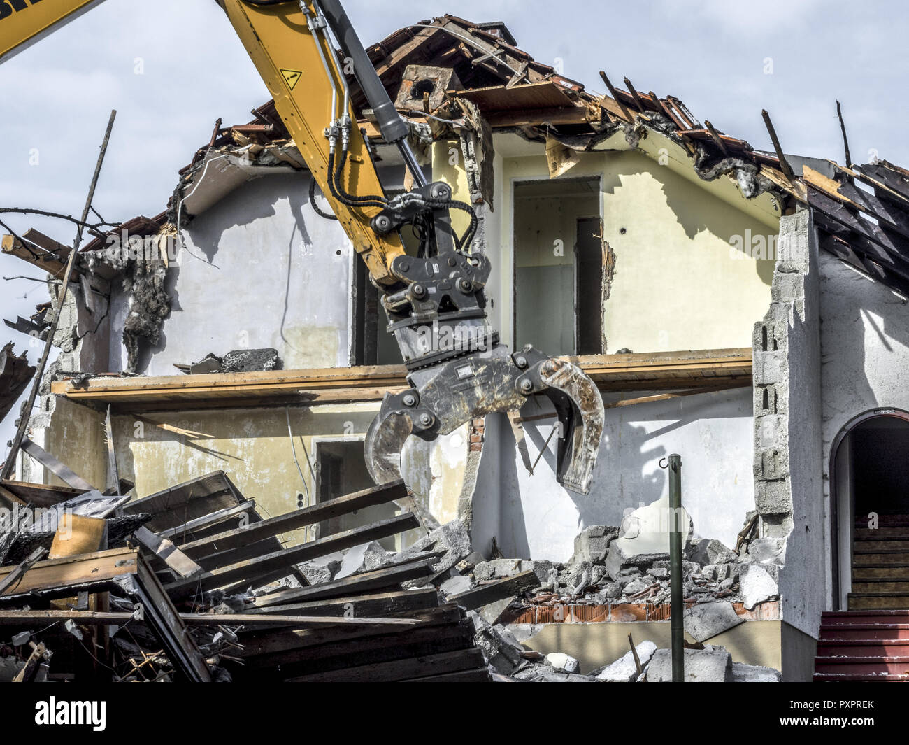 Excavator demolishing a house Stock Photo - Alamy