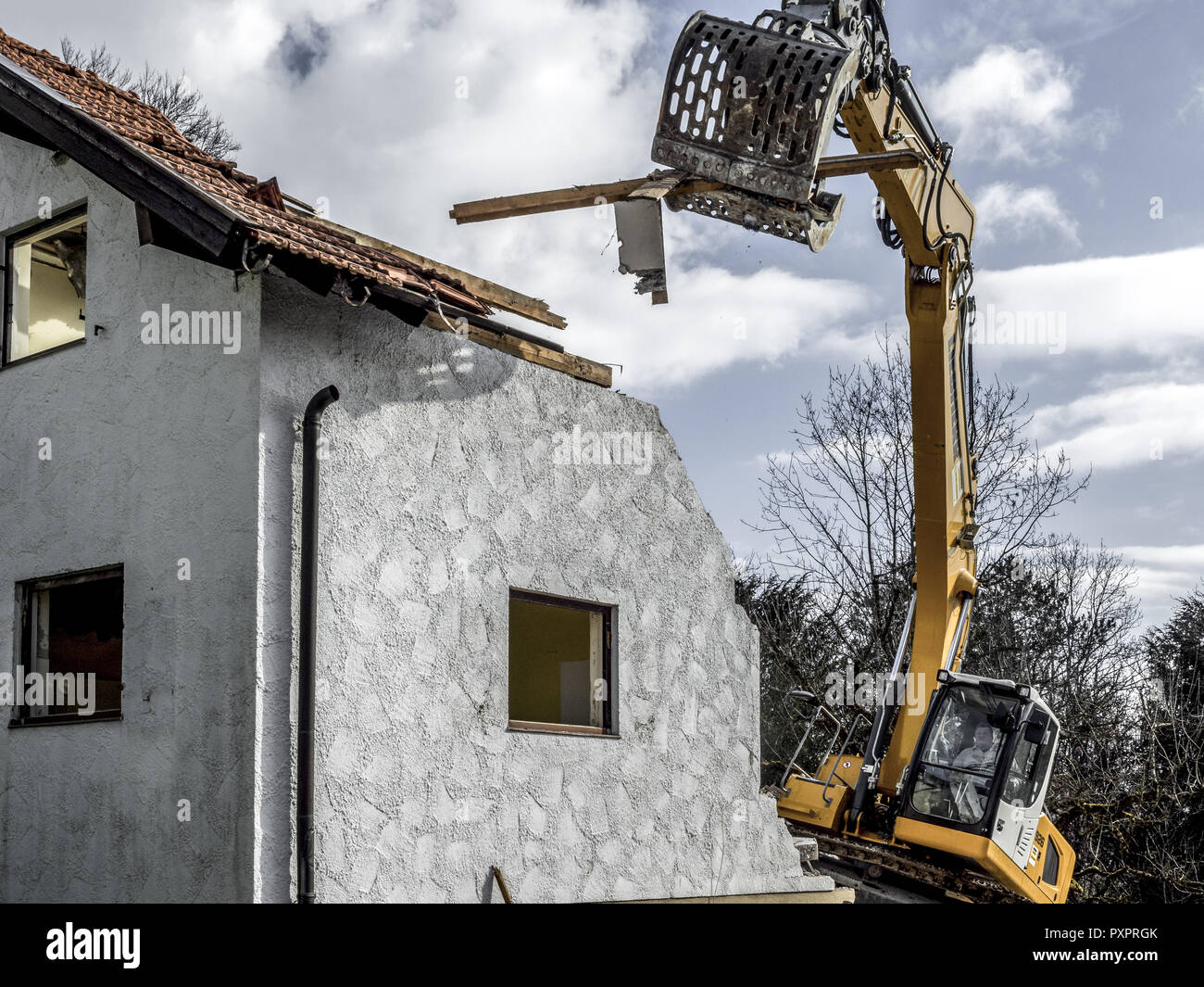 Excavator demolishing a house Stock Photo - Alamy