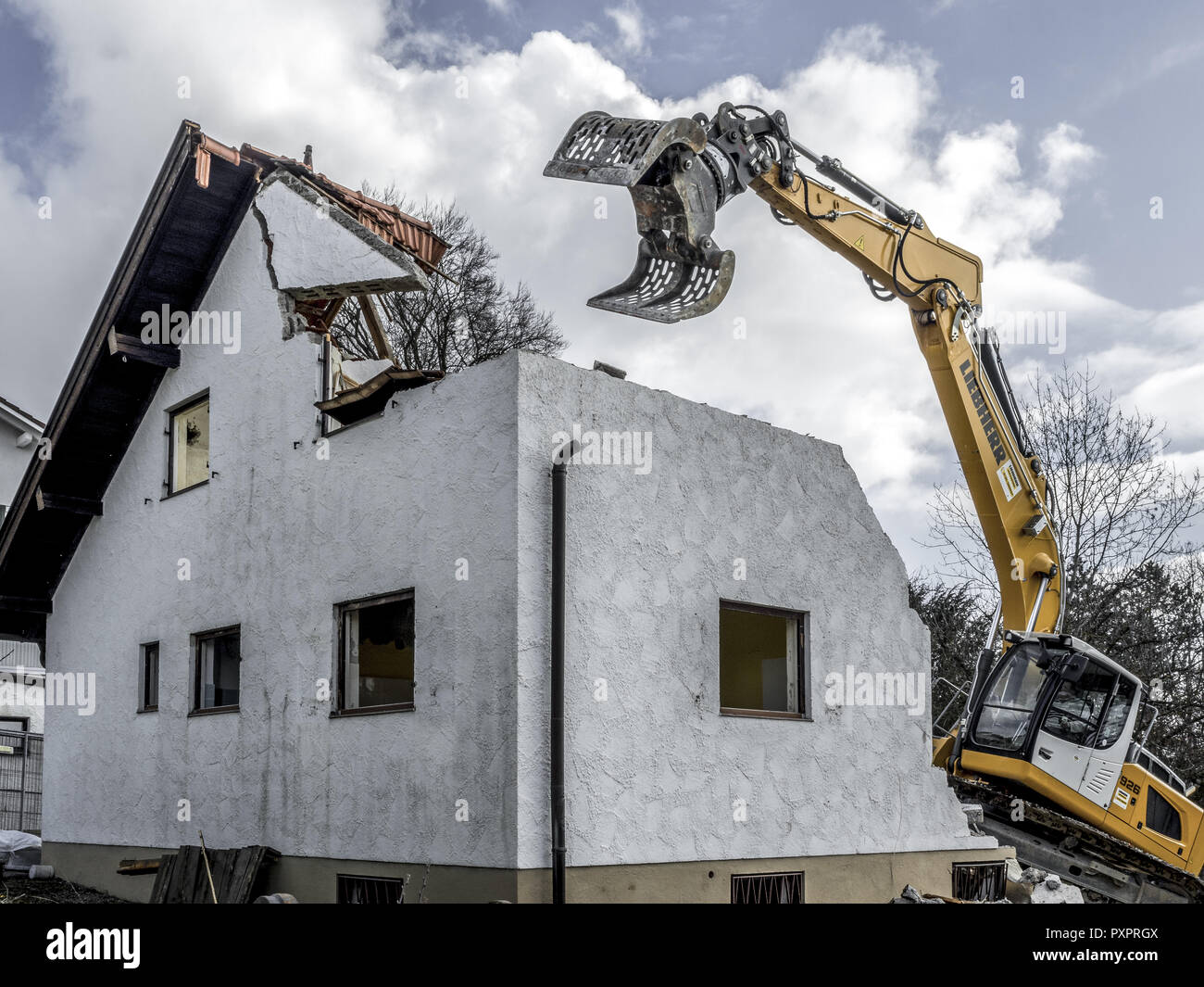 Excavator demolishing a house Stock Photo - Alamy