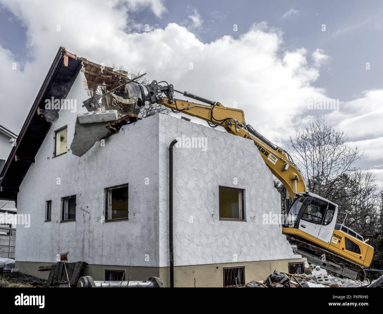 Excavator demolishing a house Stock Photo - Alamy