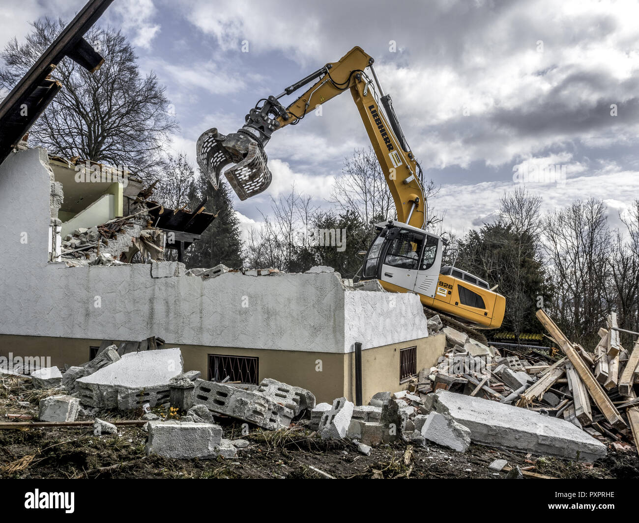 Excavator demolishing a house Stock Photo - Alamy