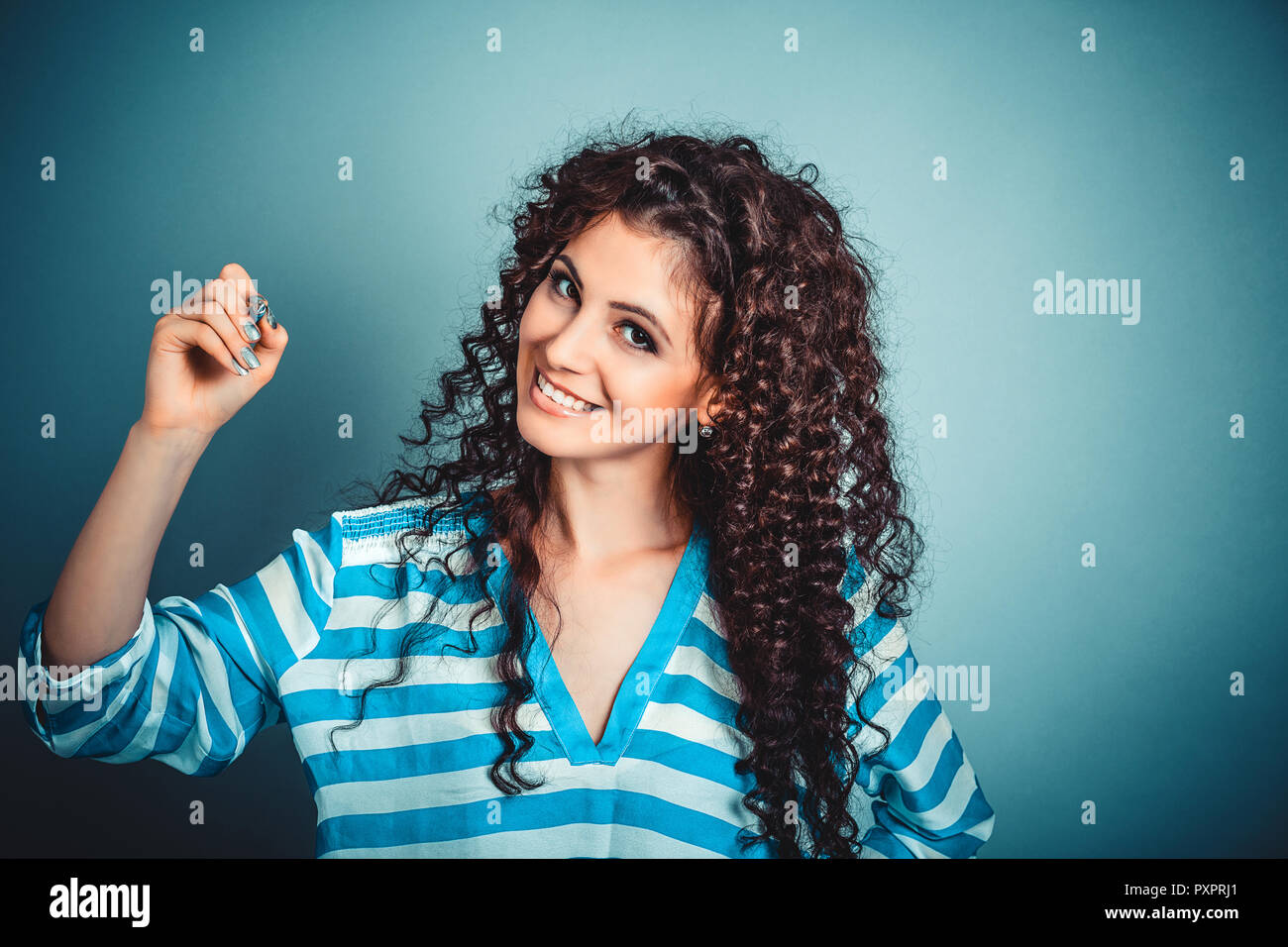 woman writing holding pen smiling happy Stock Photo - Alamy