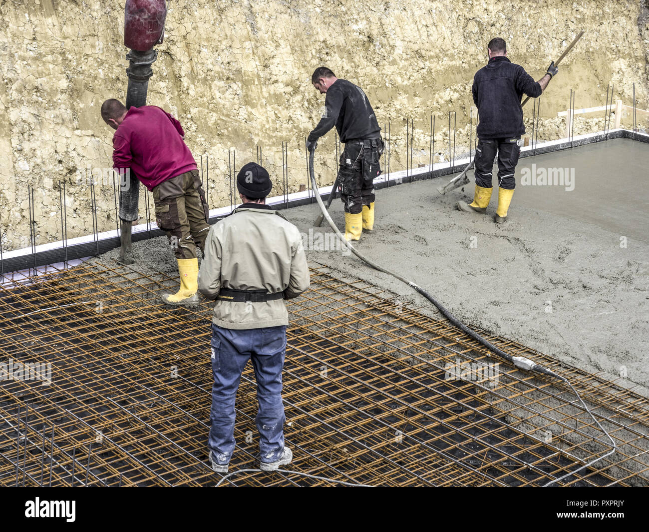 Construction worker when concreting a foundation base slab construction ...