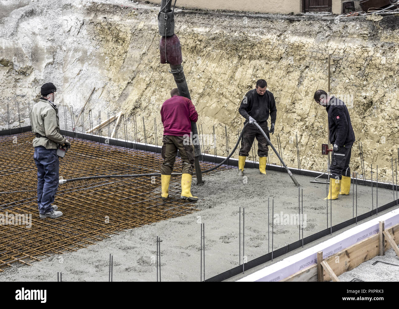 Construction worker when concreting a foundation base slab construction ...