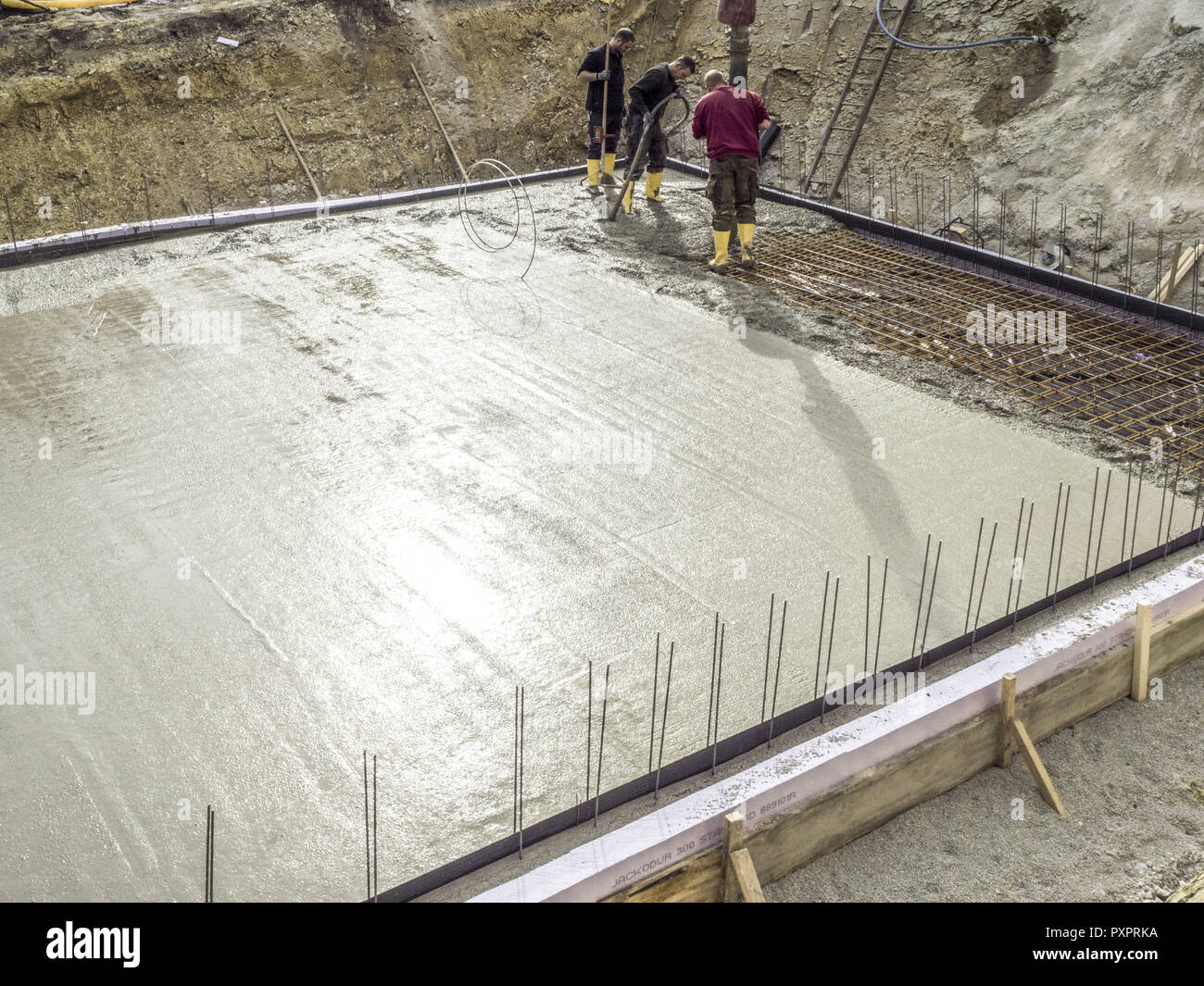 Construction worker when concreting a foundation base slab construction ...