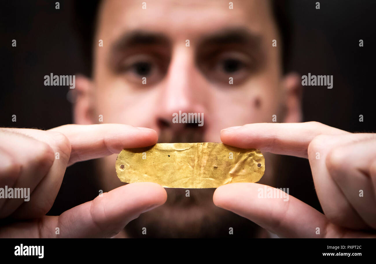 Yorkshire Museum's Assistant Curator of Archaeology Adam Parker holds a ...