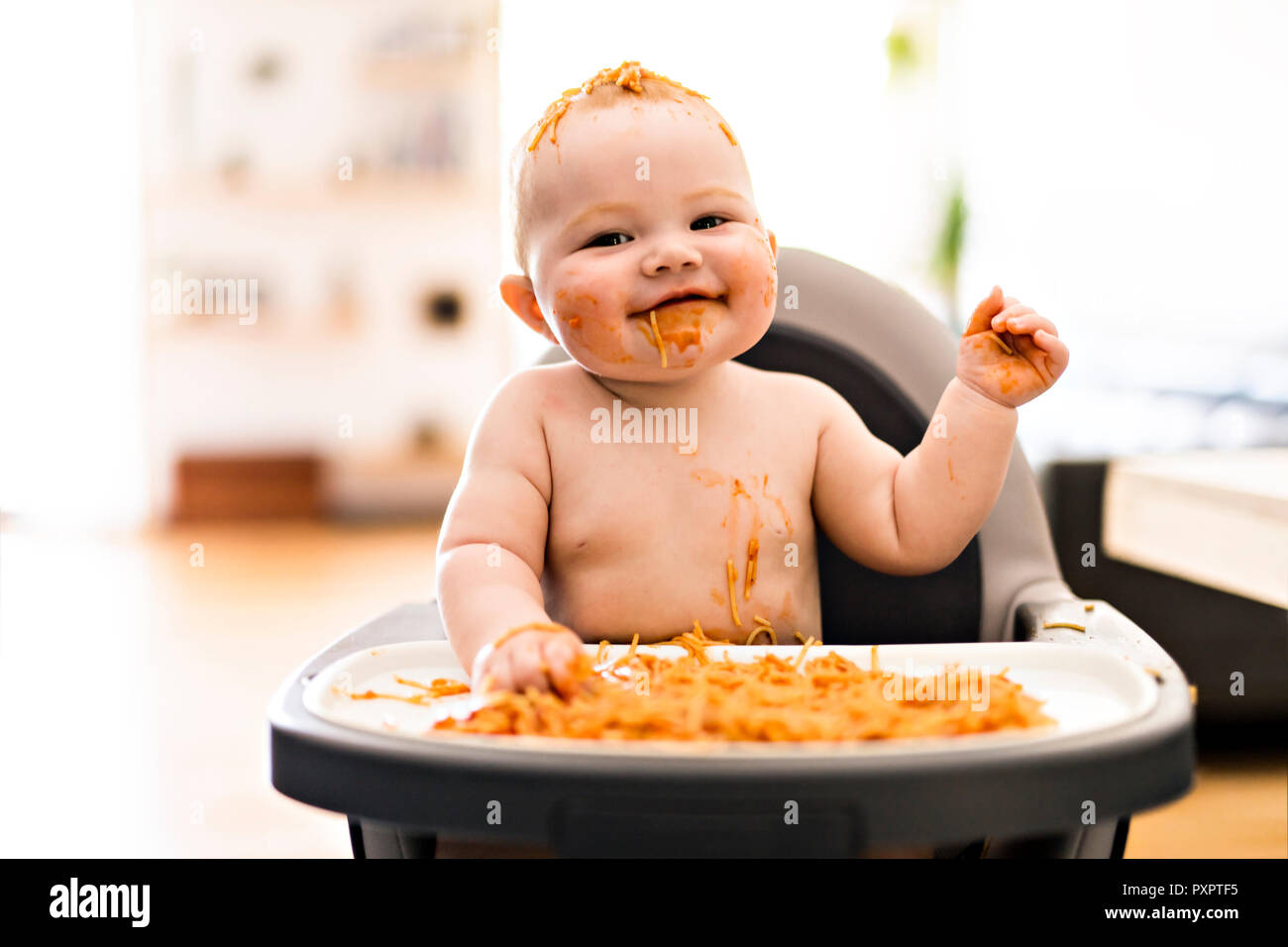 Little baby girl eating her spaghetti dinner and making a mess Stock ...